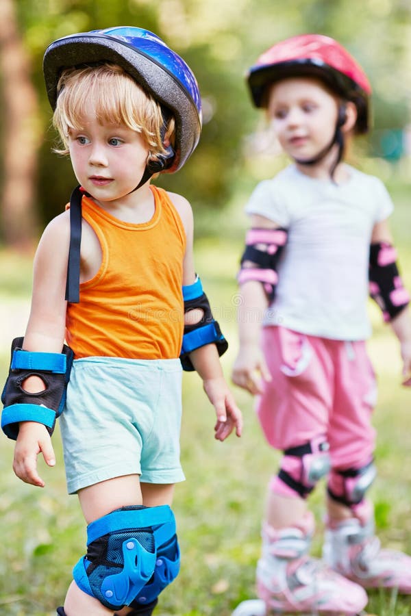 Two Kids in Rollers and Protective Equipment Stand Stock Photo - Image ...