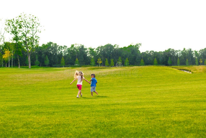 Two kids are running. stock photo. Image of grass, girl - 55761298