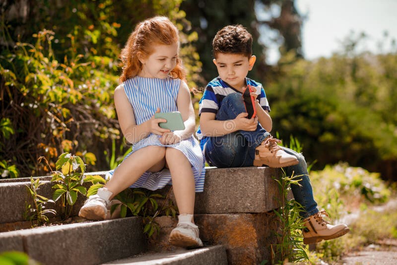 Two Kids Sitting Together and Watching Something Online Stock Image ...