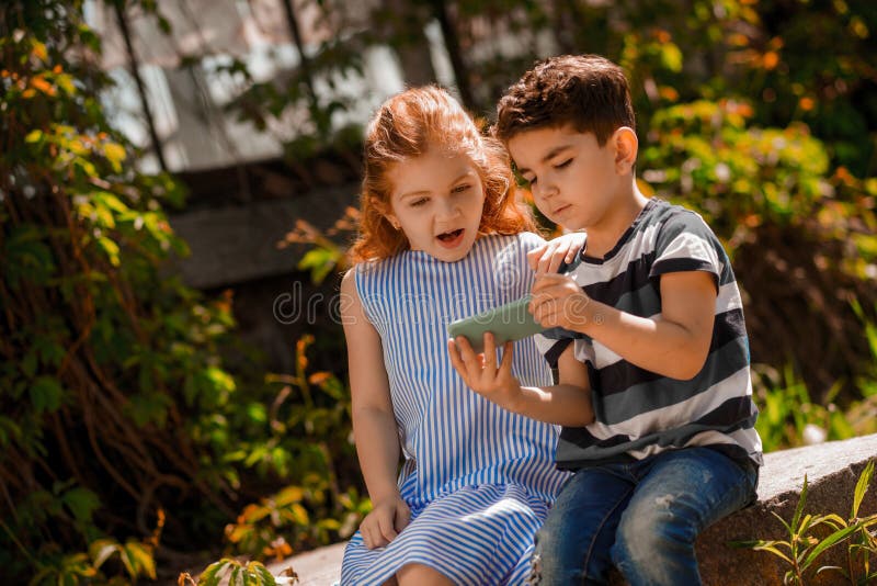 Two Kids Sitting Together and Watching Something Online Stock Image ...