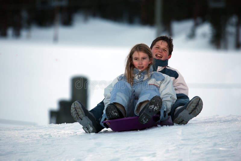 Two kids on sled stock image. Image of sister, snow, young - 10802409