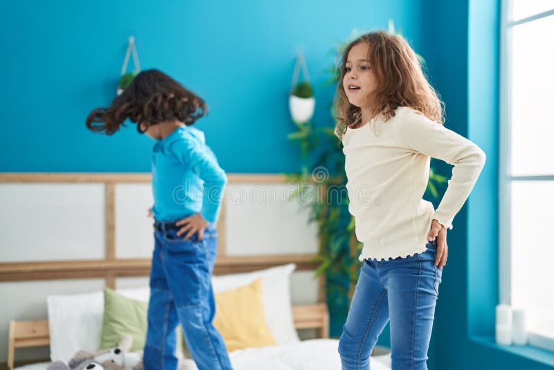 Two Kids Smiling Confident Dancing on Bed at Bedroom Stock Photo ...