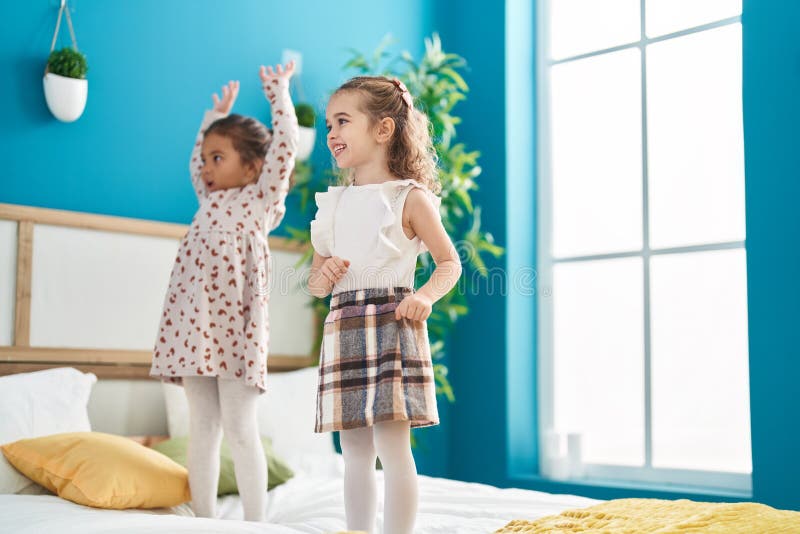 Two Kids Smiling Confident Dancing on Bed at Bedroom Stock Image ...
