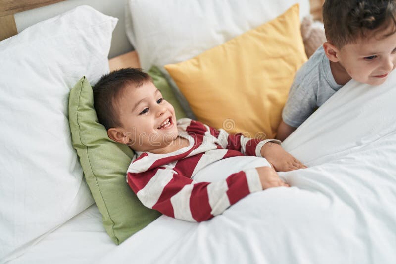 Two Kids Smiling Confident Lying on Bed at Bedroom Stock Image - Image ...