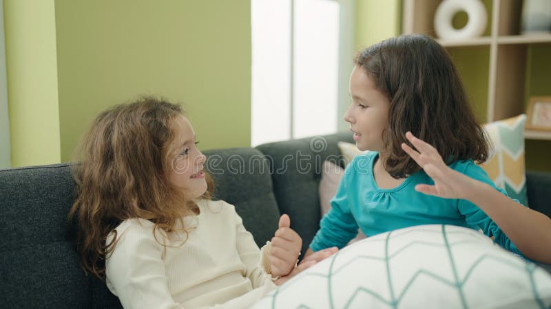Two Kids Smiling Confident Sitting on Sofa Speaking at Home Stock Photo ...
