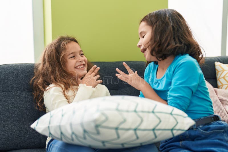 Two Kids Smiling Confident Sitting on Sofa Speaking at Home Stock Photo ...