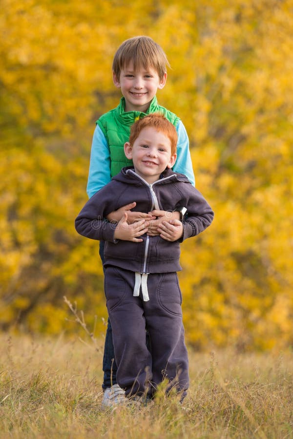 Two Kids Standing Together on Autumn Landscape Stock Image - Image of ...