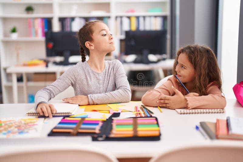 Two Kids Students Sitting on Table Drawing on Notebook Paper at ...