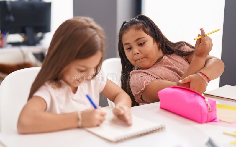 Two Kids Students Sitting on Table Drawing on Notebook Paper at ...