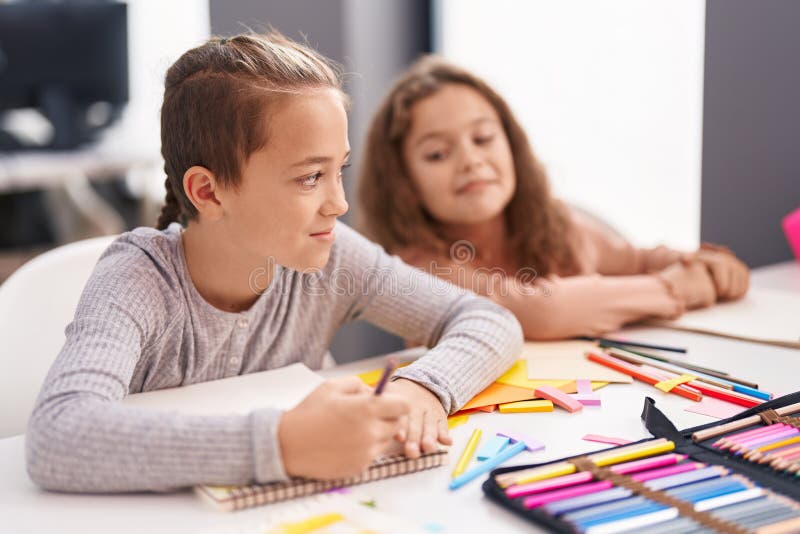 Two Kids Students Sitting on Table Drawing on Notebook Paper at ...