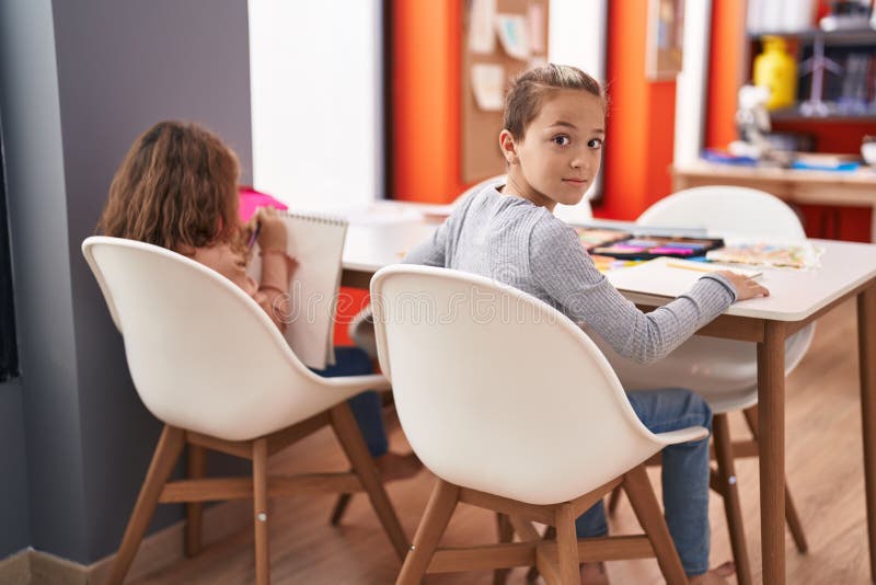 Two Kids Students Sitting on Table Drawing on Notebook Paper at ...