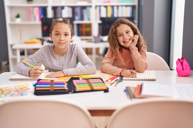 Two Kids Students Sitting on Table Drawing on Notebook Paper at ...