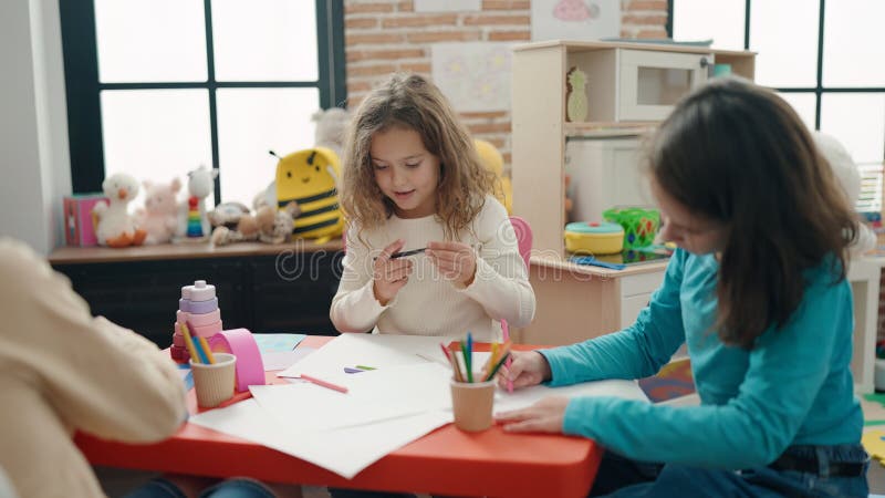 Two Kids Students Sitting on Table Drawing on Paper at Kindergarten ...