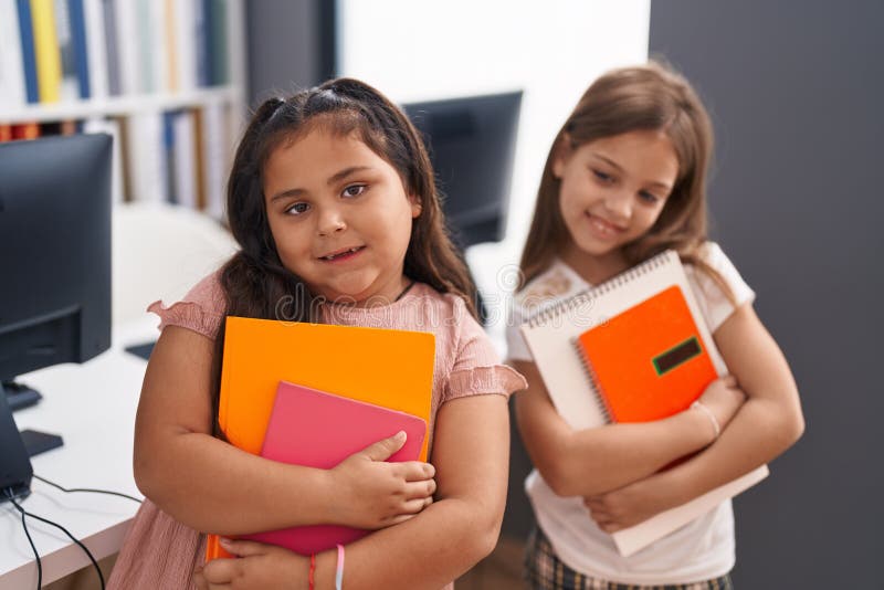 Two Kids Students Smiling Confident Holding Books at Classroom Stock ...