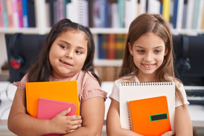 Two Kids Students Smiling Confident Holding Books at Classroom Stock ...