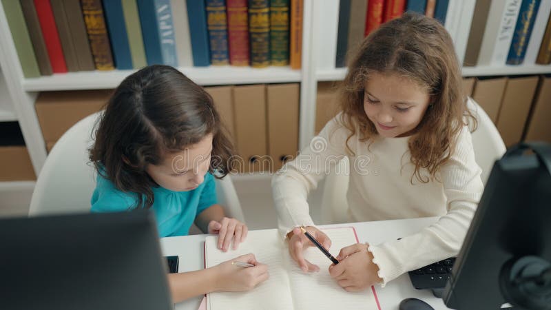 Two Kids Students Using Computer Writing on Notebook at Classroom Stock ...