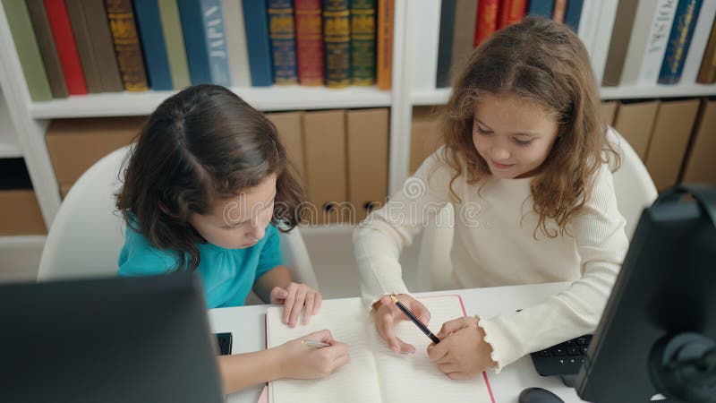 Two Kids Students Using Computer Writing on Notebook at Classroom Stock ...