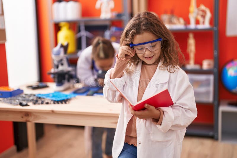 Two Kids Students Using Microscope Reading Notebook at Laboratory ...