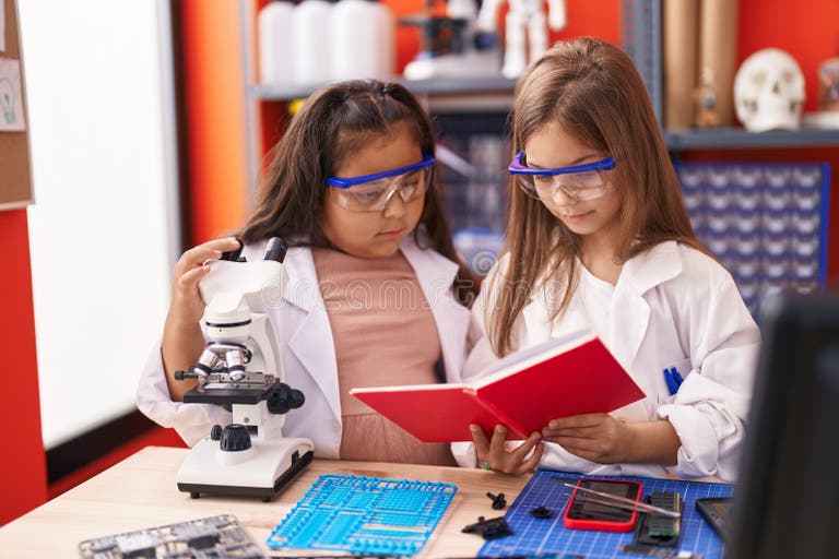 Two Kids Students Using Microscope Reading Notebook at Laboratory ...