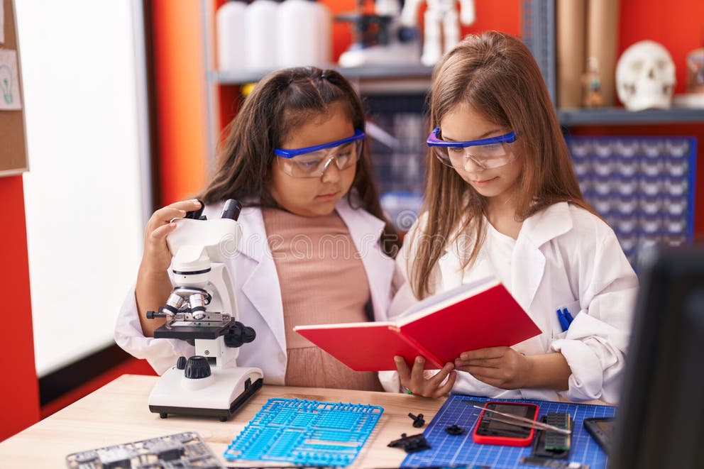 Two Kids Students Using Microscope Reading Notebook at Laboratory ...