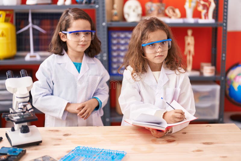 Two Kids Students Using Microscope Writing on Notebook at Kindergarten ...