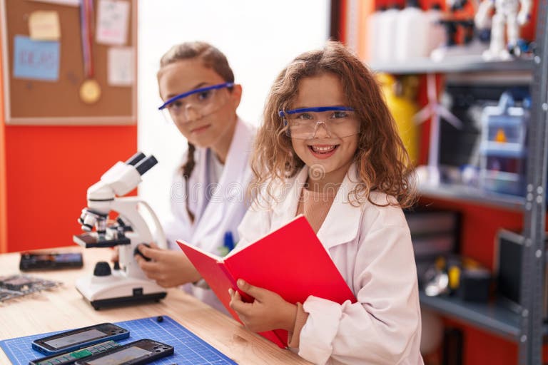Two Kids Students Using Microscope Writing on Notebook at Laboratory ...