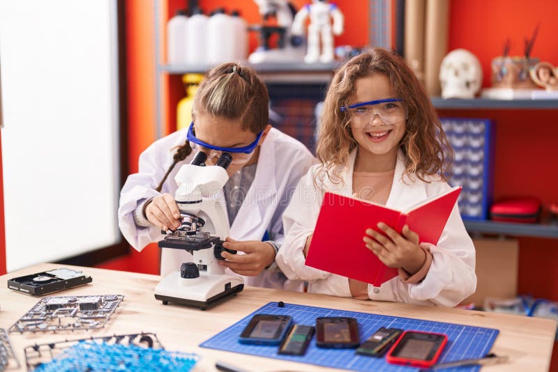 Two Kids Students Using Microscope Writing on Notebook at Laboratory ...