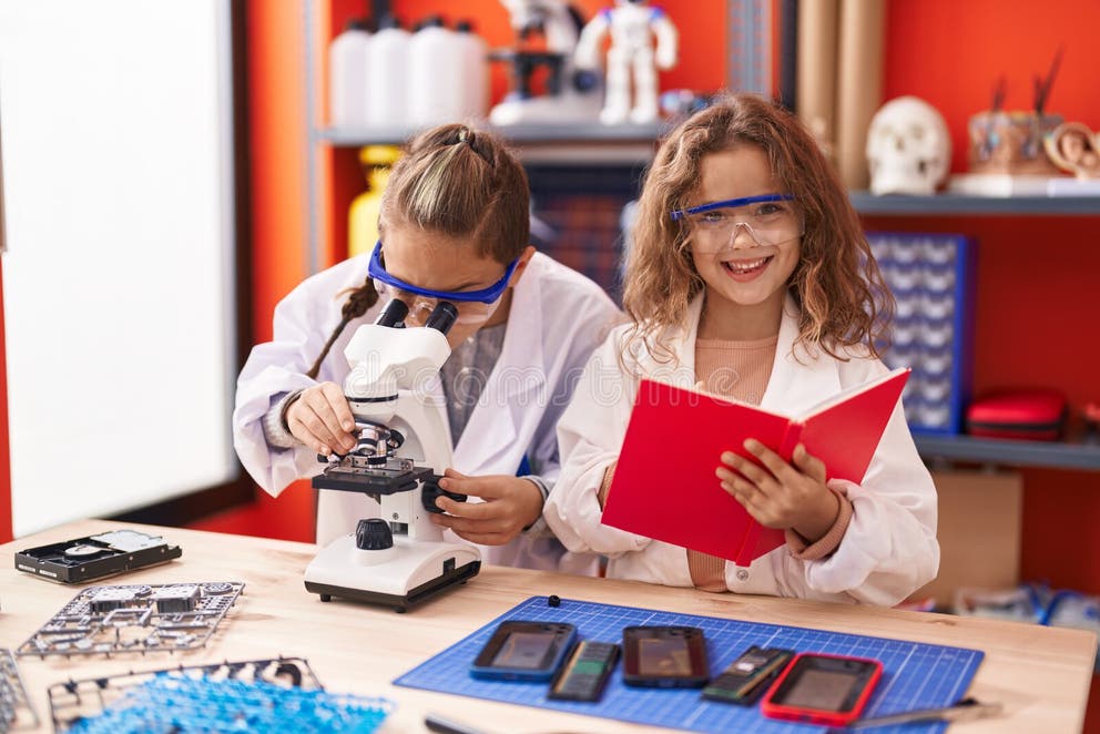 Two Kids Students Using Microscope Writing on Notebook at Laboratory ...