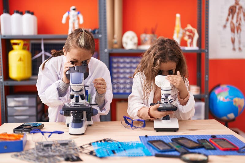 Two Kids Students Using Microscopes Standing at Laboratory Classroom ...