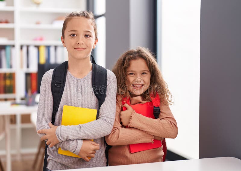 Two Kids Students Wearing Backpack Holding Book at Classroom Stock ...