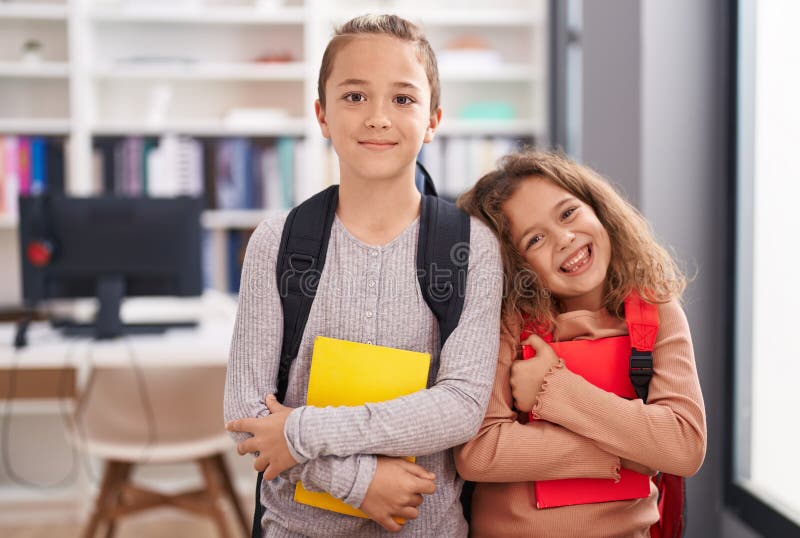 Two Kids Students Wearing Backpack Holding Book at Classroom Stock ...