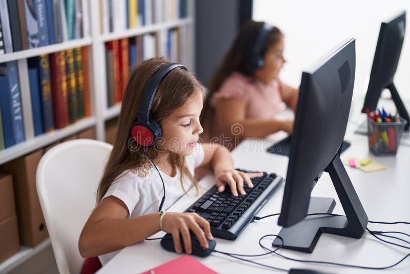 Two Kids Students Wearing Headphones Using Computer Studying at ...