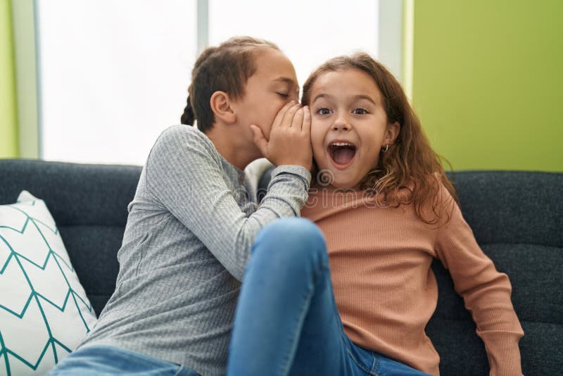 Two Kids Telling Secret Sitting on Sofa at Home Stock Image - Image of ...