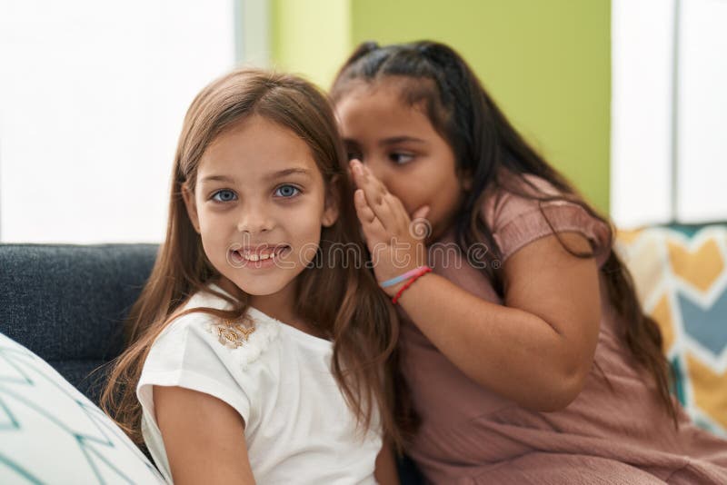 Two Kids Telling Secret Sitting on Sofa at Home Stock Image - Image of ...