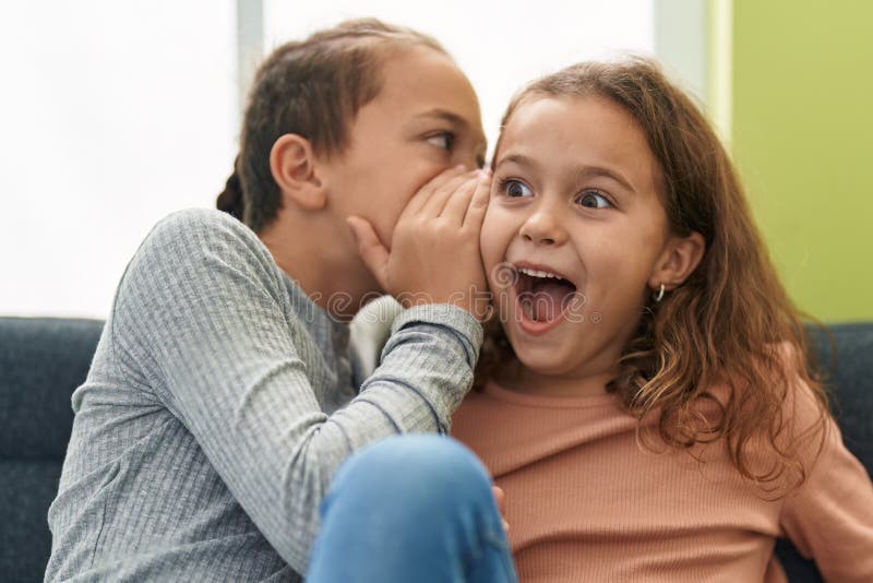 Two Kids Telling Secret Sitting on Sofa at Home Stock Image - Image of ...
