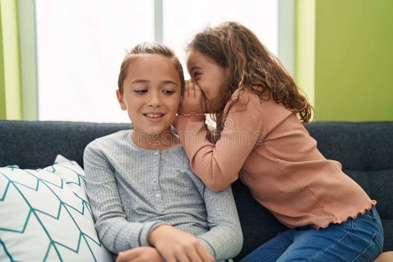 Two Kids Telling Secret Sitting on Sofa at Home Stock Image - Image of ... Two Kids Telling Secret Sitting on Sofa at Home Stock Image - Image of ...