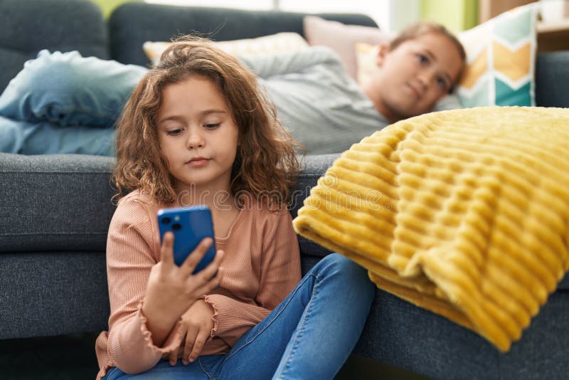 Two Kids Watching Tv and Using Smartphone at Home Stock Photo - Image ...