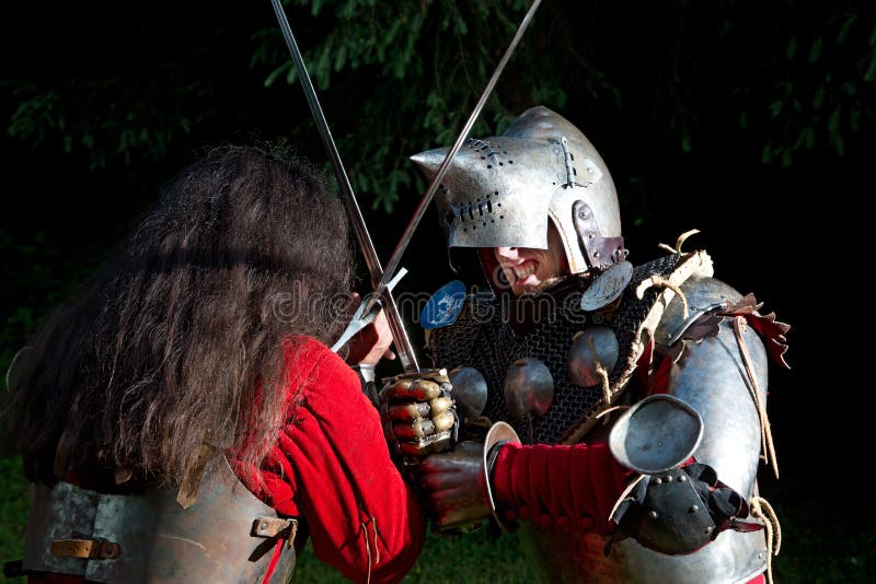 Two Knights Fighting with Swords in the Woods at Night Stock Photo ...