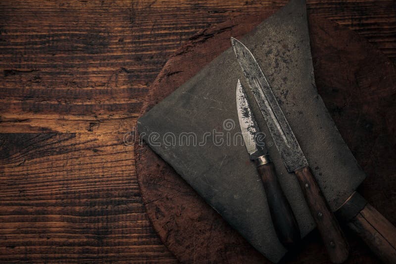 Two Knives on a Big Rusty Cleaver on Top of a Rustic Table Top Stock ...