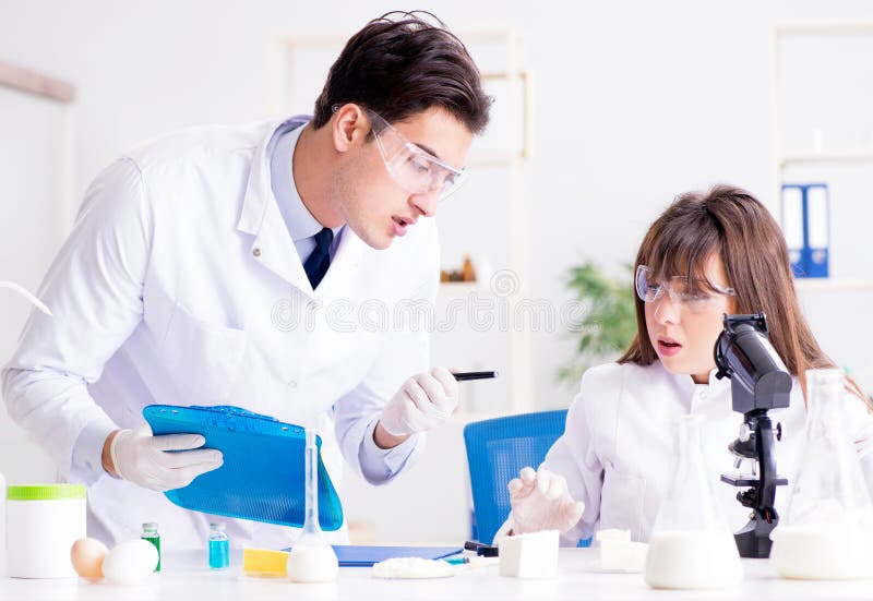 Two Lab Doctor Testing Food Products Stock Photo - Image of microscope ...