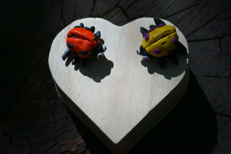 Two Ladybugs Made of Plasticine on a Wooden Box in the Form of a Heart ...