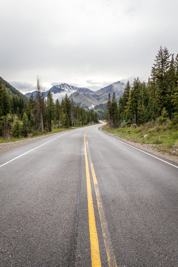 Two Lane Road in Mountains stock photo. Image of snow - 190727904