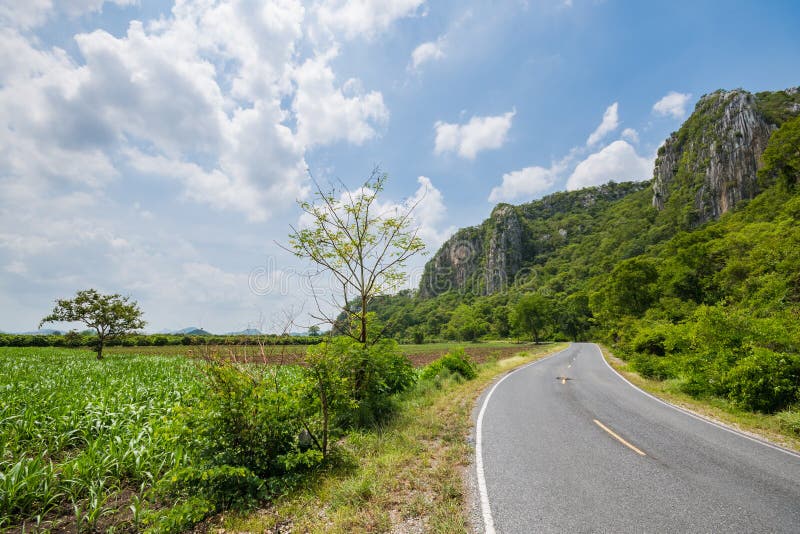 Two Lane Road Surrounded with Mountain and Forest. Stock Photo - Image ...
