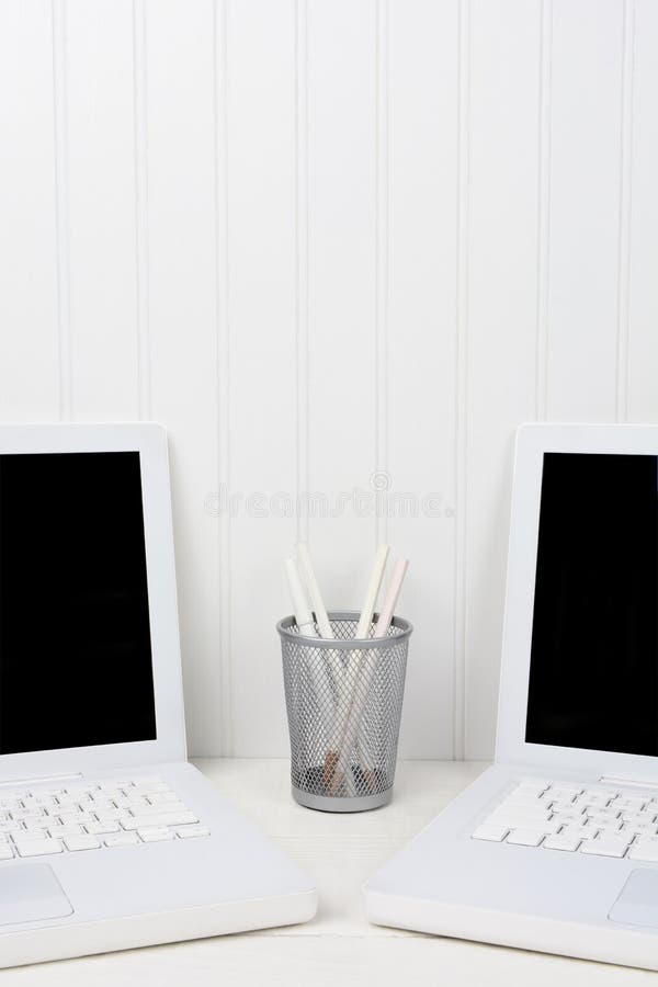 Two Laptops and Pencil Cup Vertical Stock Photo - Image of black ...