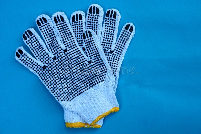 Two Construction Gloves Made of Fabric on a Blue Background Stock Photo ...