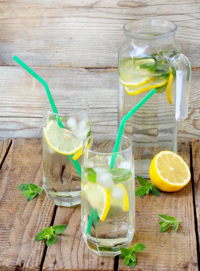 Two Large Glass of Cold Lemonade with Ice, Lemon, Mint Leaves Stock ...