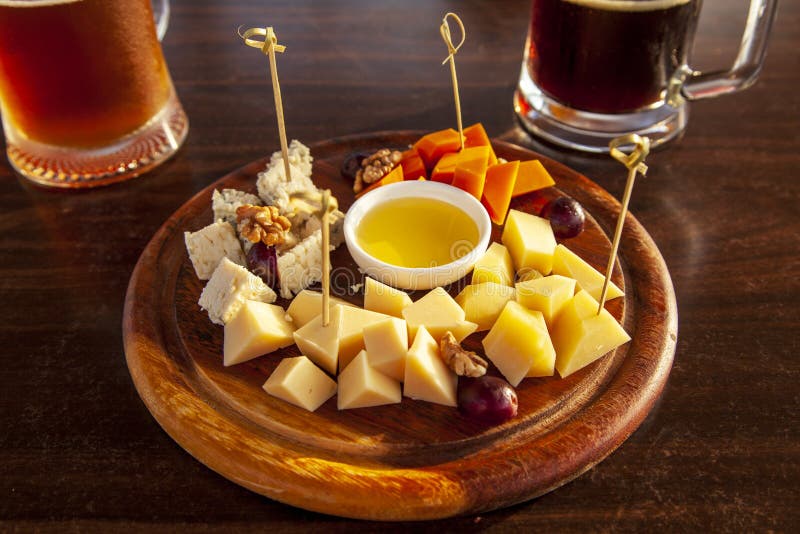 Two Large Mugs of Beer and a Cheese Plate, Assorted Cheeses Stock Image ...