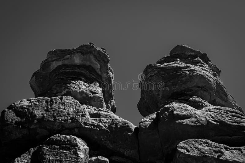 Two Large Rocks with Some Sort of Structure and Light on Them Stock ...