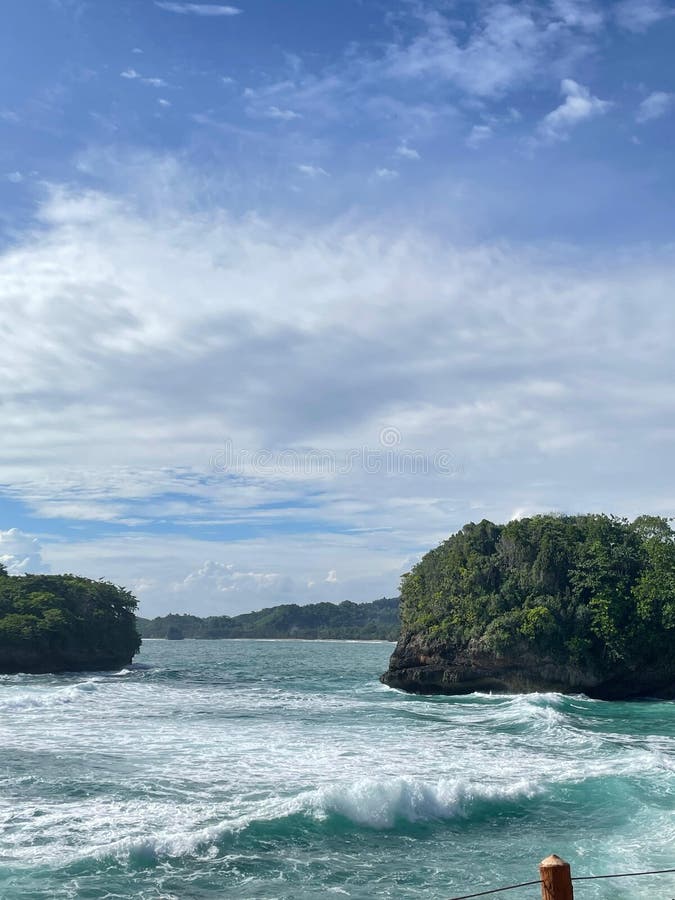 Two Large Rocks in the Middle of the Beach Stock Image - Image of water ...