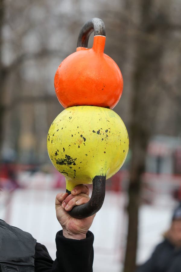 Two Large Round Metal Weights in the Hands of a Man Stock Photo - Image ...